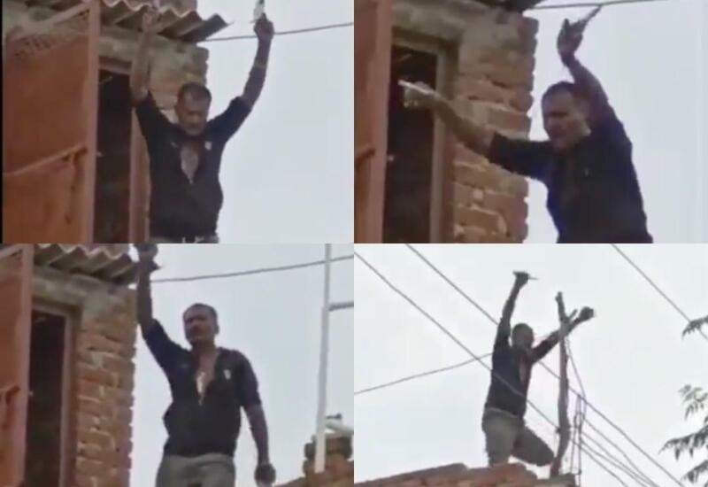 Man dances on rooftop with pistols in hands after firing at bank guard ...